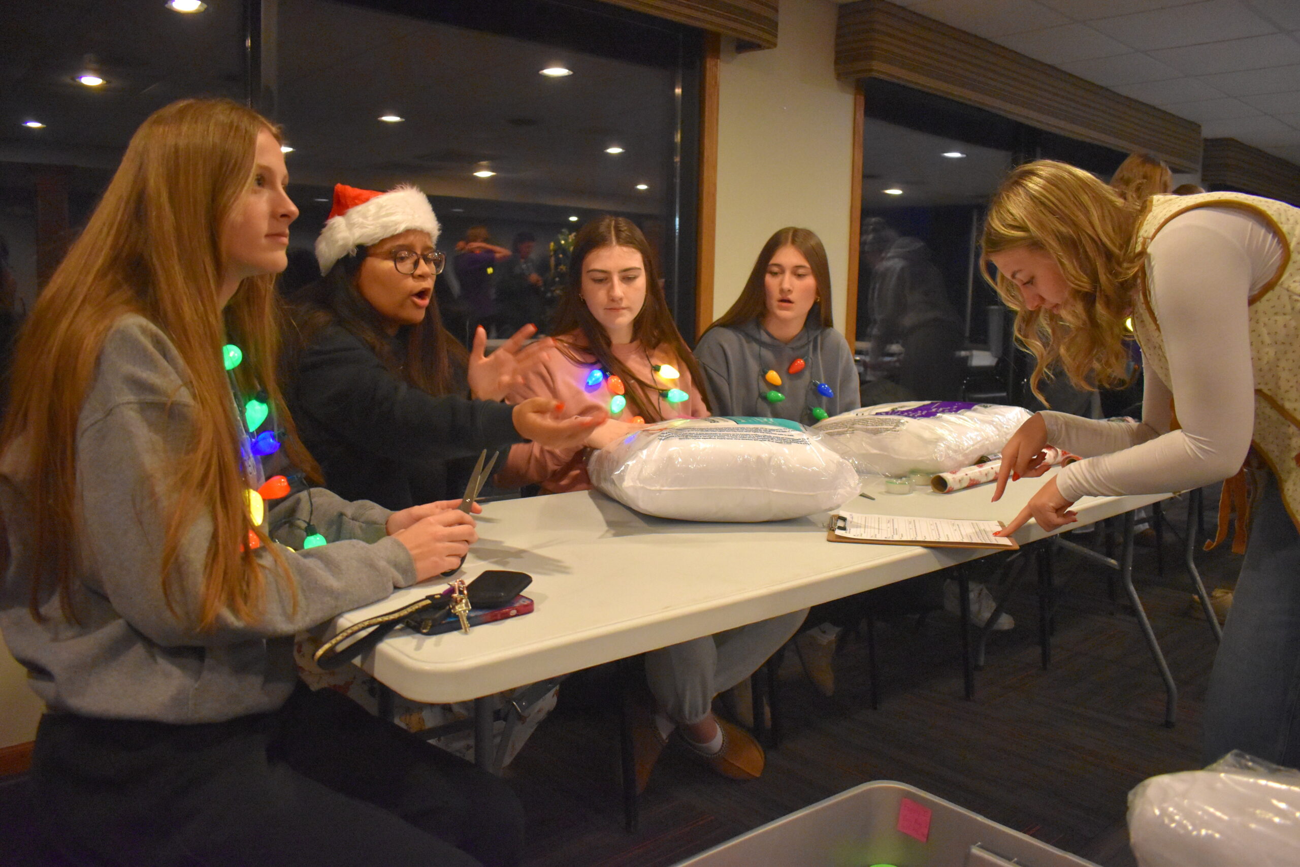 Students wrap Christmas gifts for Optimists Adopt-a-Family | News ...